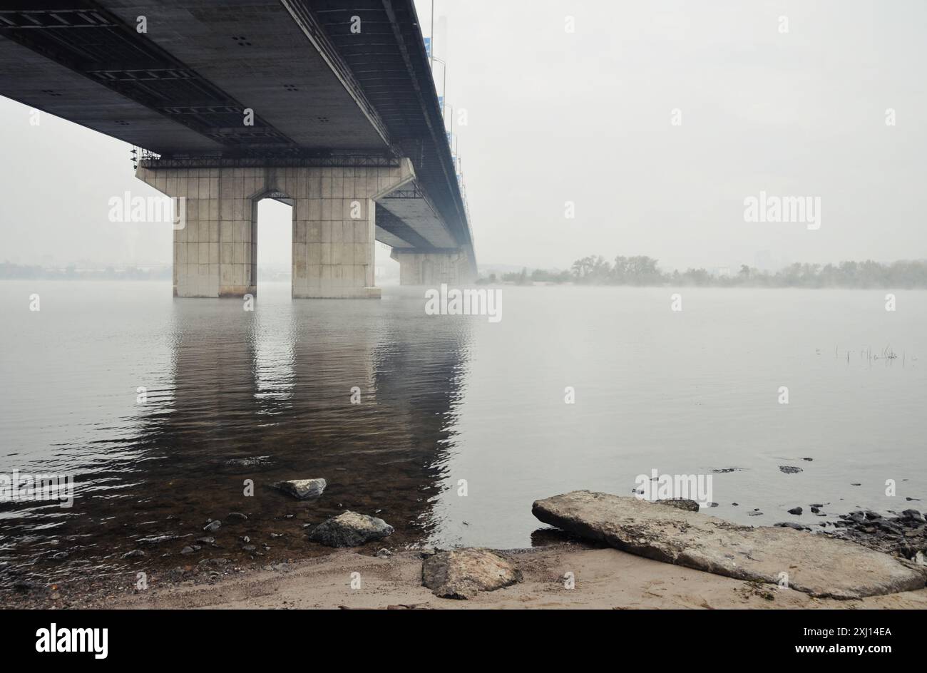 Bridge disappearing in a dense fog. Perspective view of the bridge from ...