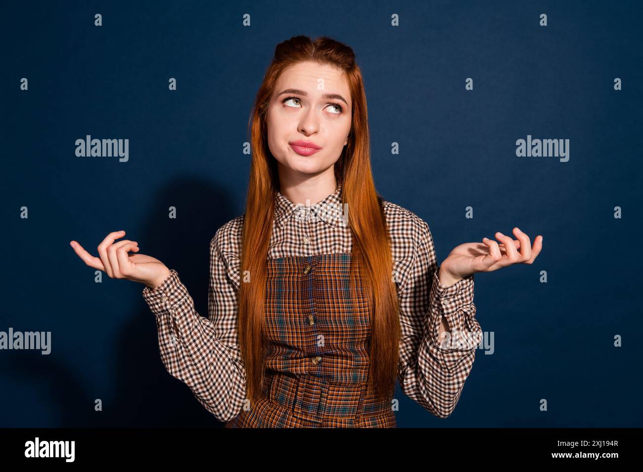Photo of doubtful unsure lady dressed plaid outfit rising arms looking ...
