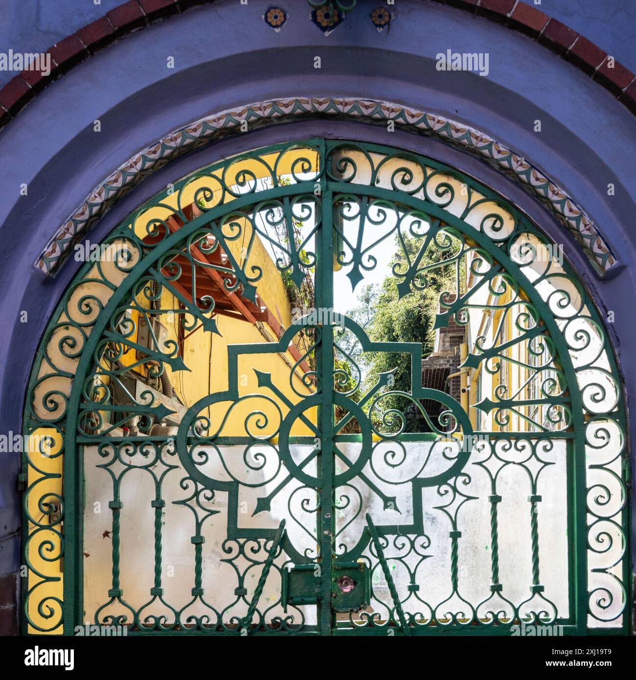 Arched shape window with decorative wrought iron pattern in Coyoacan ...