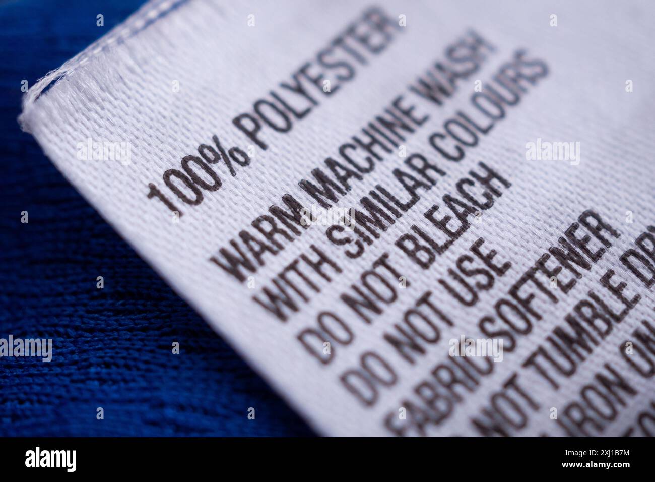 Polyester clothing label with laundry care instructions tag on blue ...