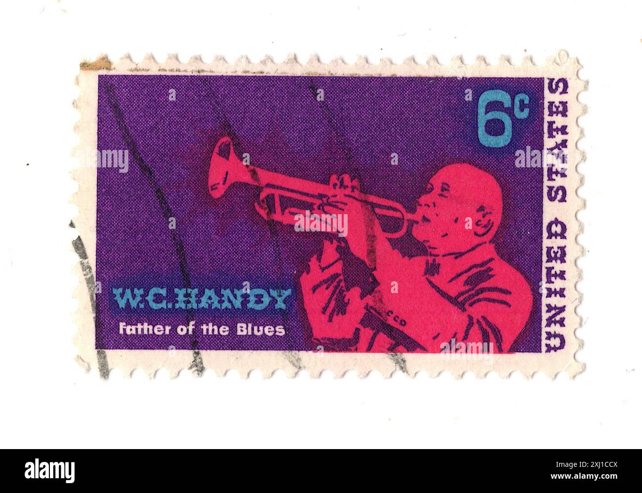 A vintage trumpet player postage stamp from the USA on a white ...