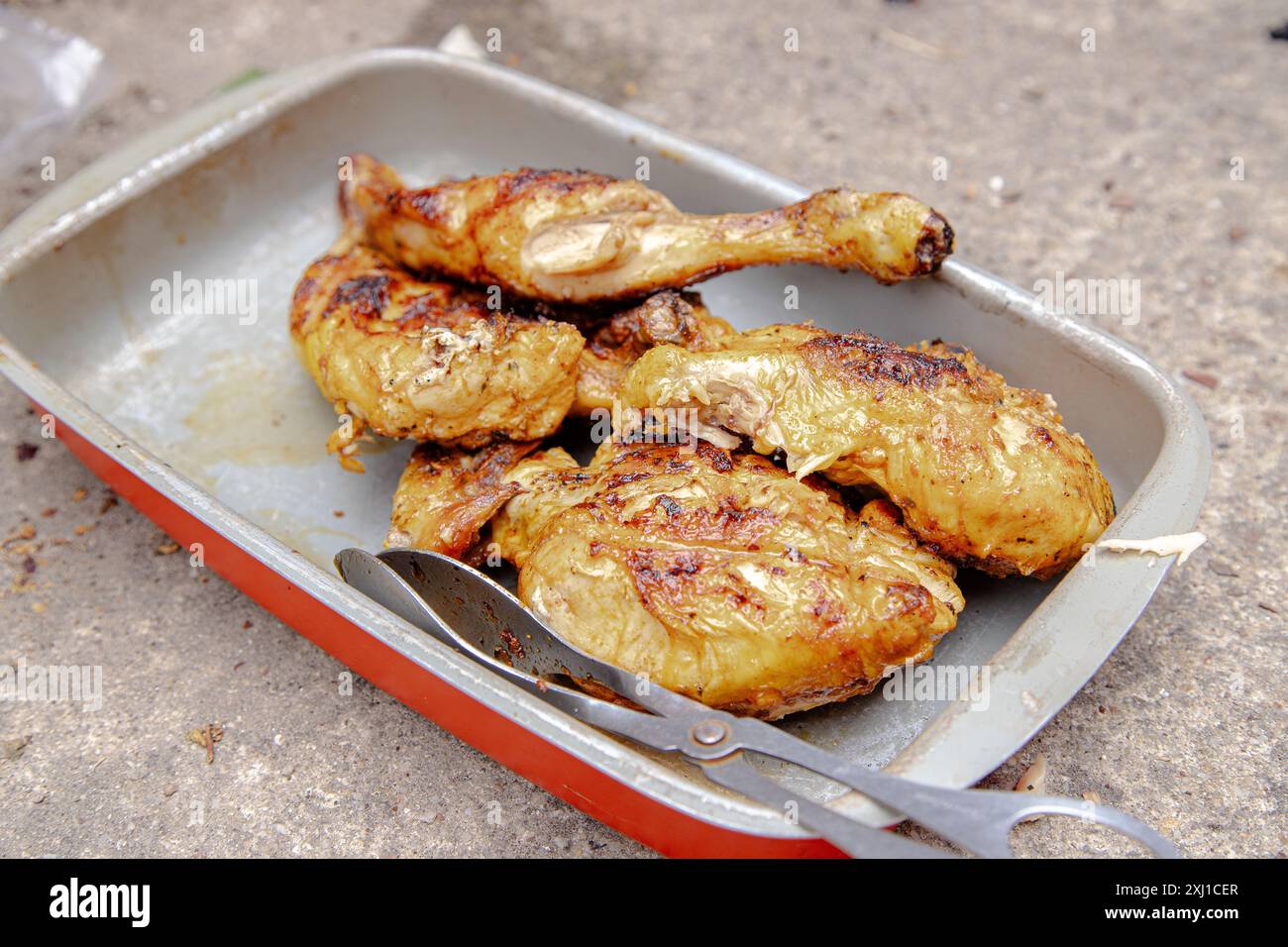 Juicy and seasoned pieces of chicken after grilling over charcoal. A ...