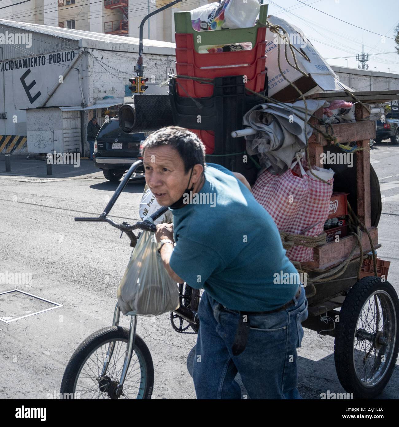 A man pulling a loaded cart on a street in Cuauhtémoc, Mexico City ...