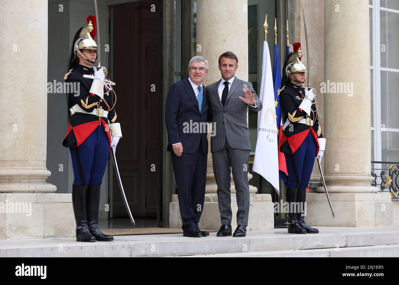 French President Emmanuel Macron, right, welcomes International Olympic ...