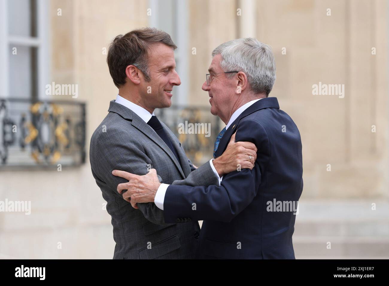 French President Emmanuel Macron, left, welcomes International Olympic ...