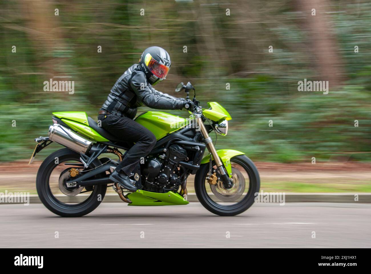Triumph motorcycle and rider on the highway Stock Photo - Alamy
