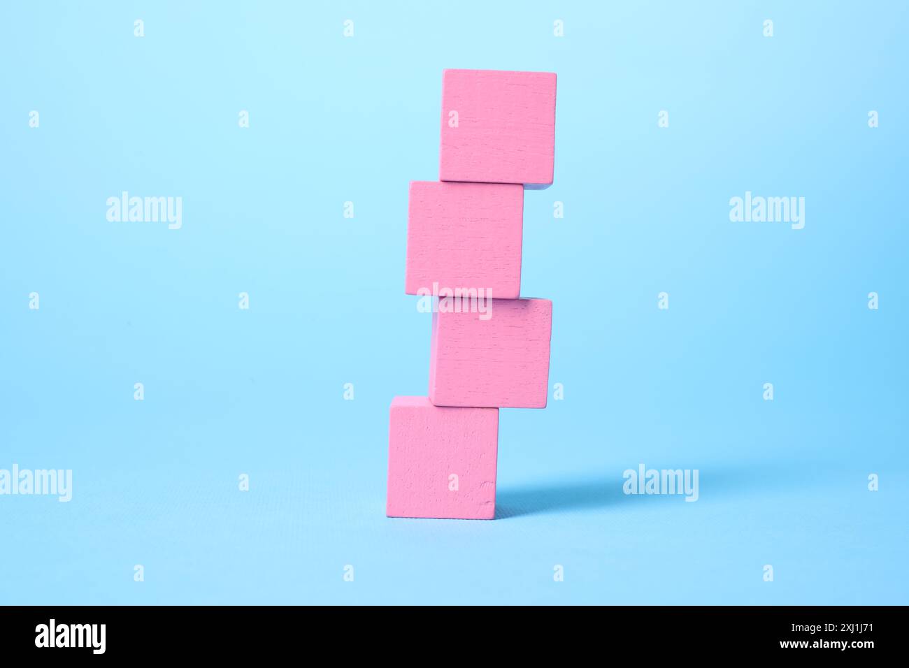 Many blank pink cubes on light blue background Stock Photo - Alamy