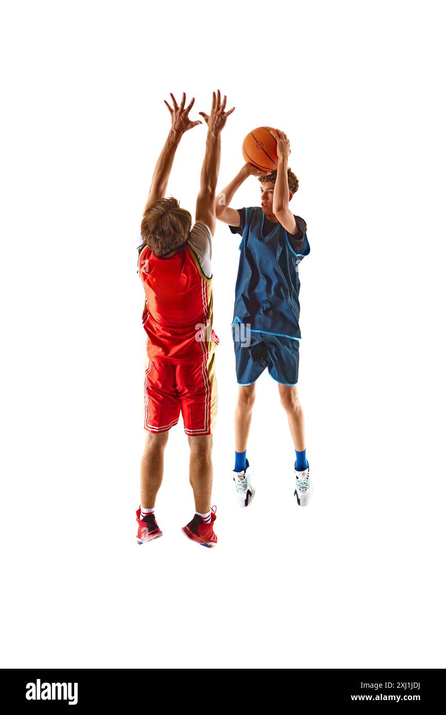 Game as player wearing red-jersey attempts shot under heavy pressure ...