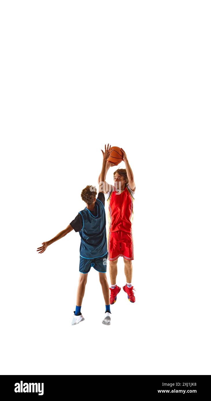 Basketball player in blue taking precise shot, while his opponent in ...