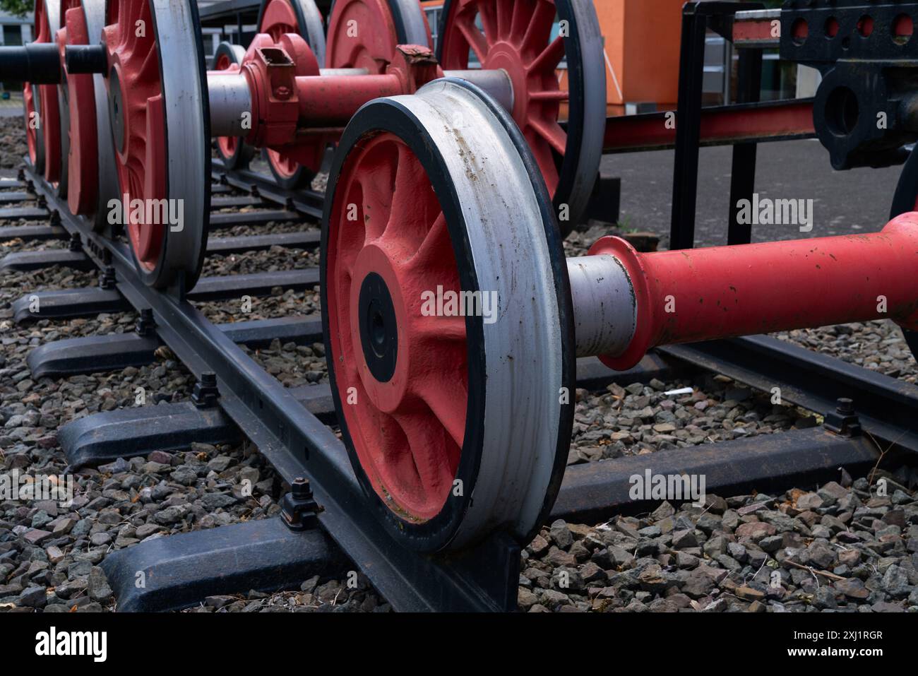 Red train wheels on a set of tracks, close-up view Stock Photo - Alamy