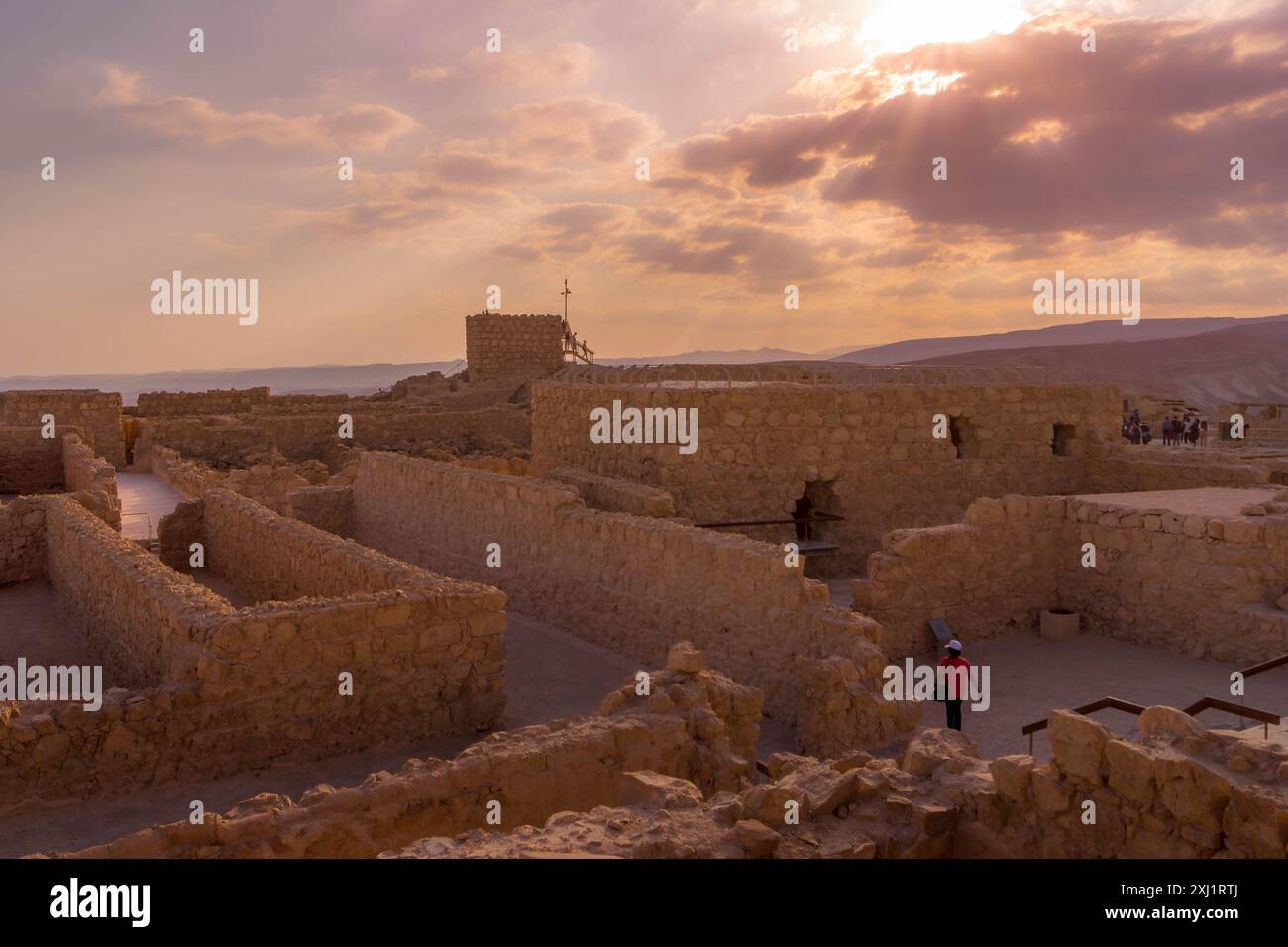 The tourists walking among the wall of Masada national reserve, a ...