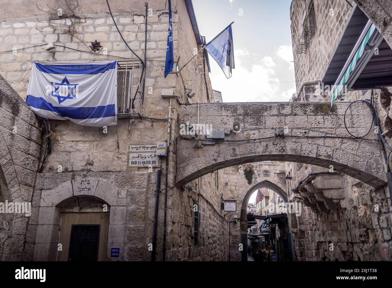 The narrow Bab El-Hadid road in old city of Jerusalem, with the Israel ...