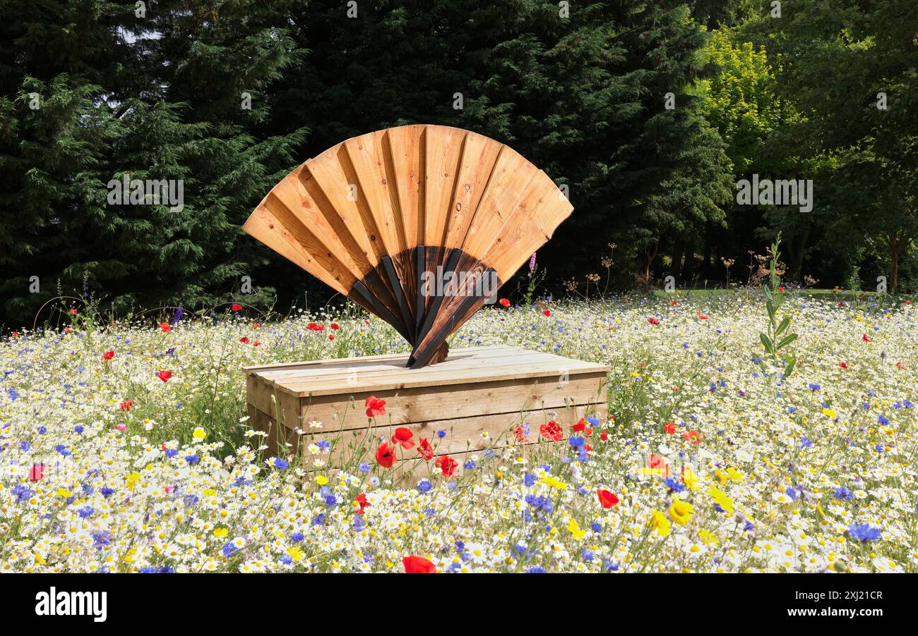 Wood fan sculpture in a flower bed at the garden of Burghley House ...
