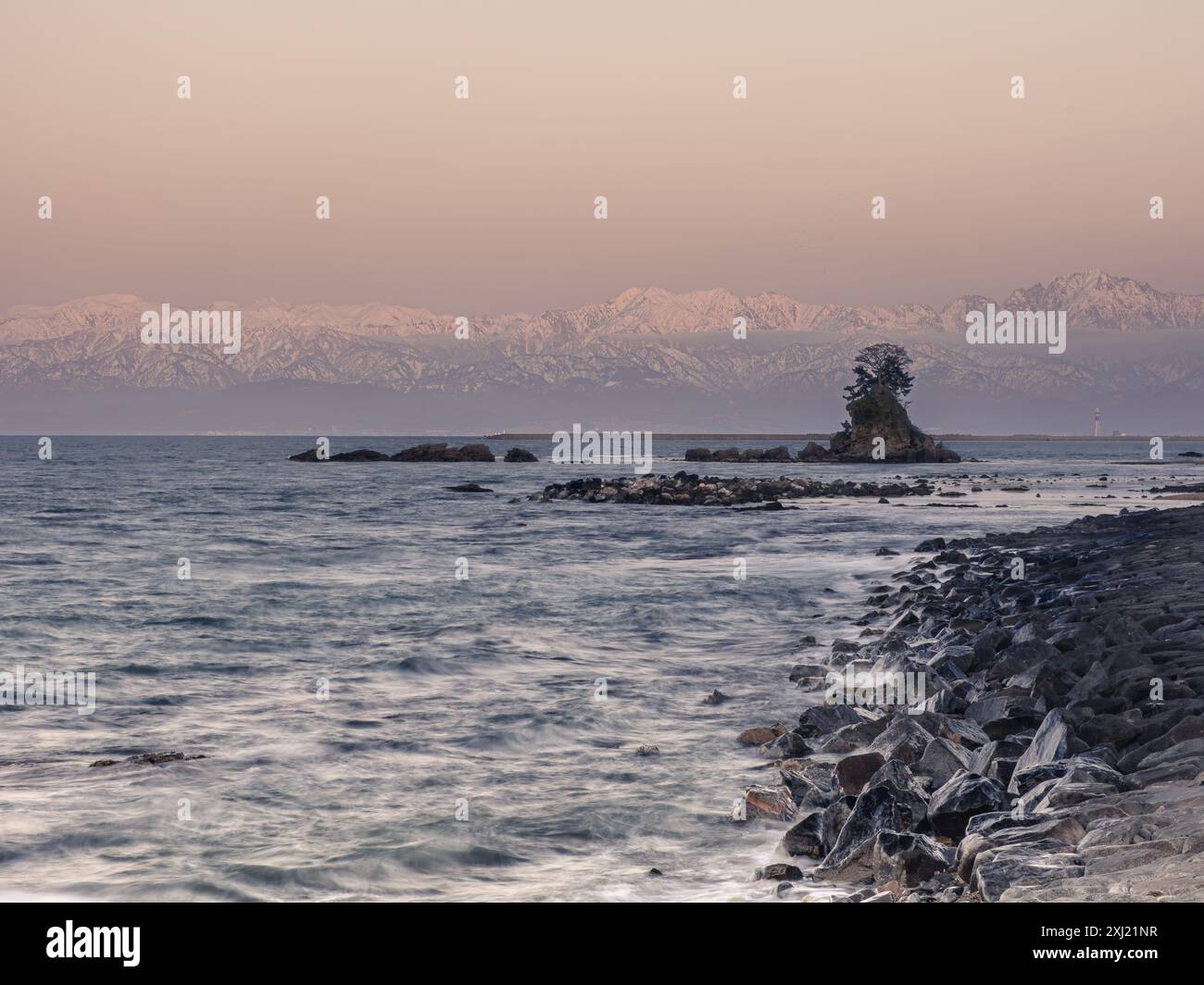 Silent Serenity: Sunset Over Snowy Peaks at Amaharashi Coast, Toyama ...