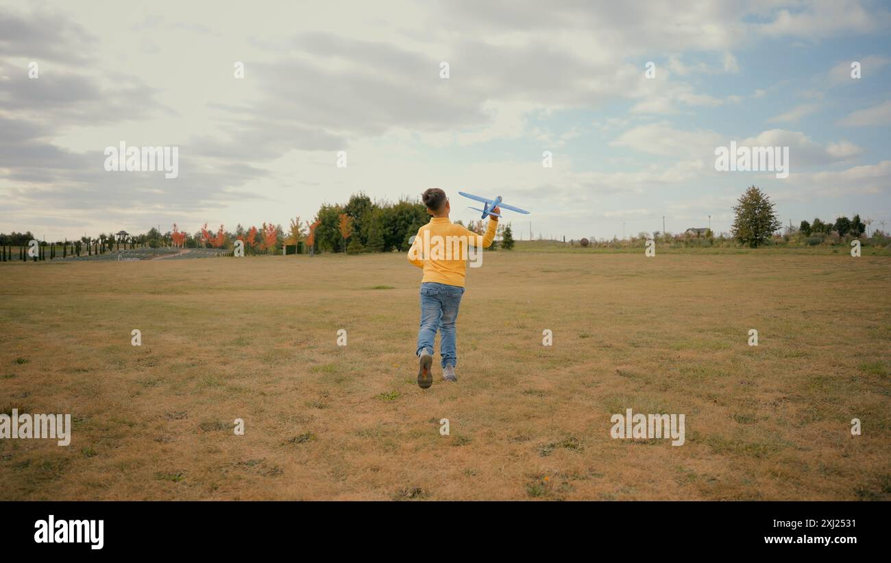 Joyful happy Caucasian little boy child kid launch throwing flying ...