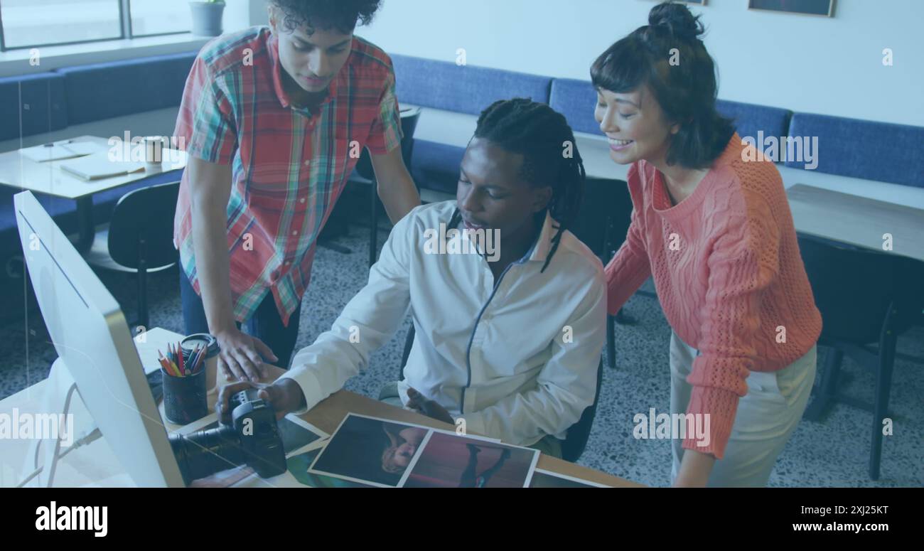 Asian intern, biracial intern, and African American colleague review ...