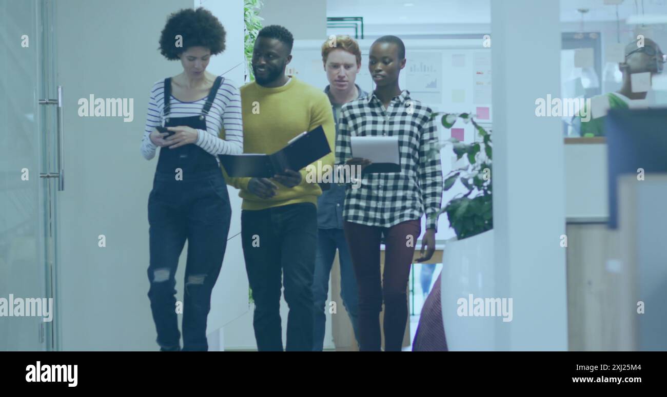 Diverse group of colleagues walking through office hallway. African ...