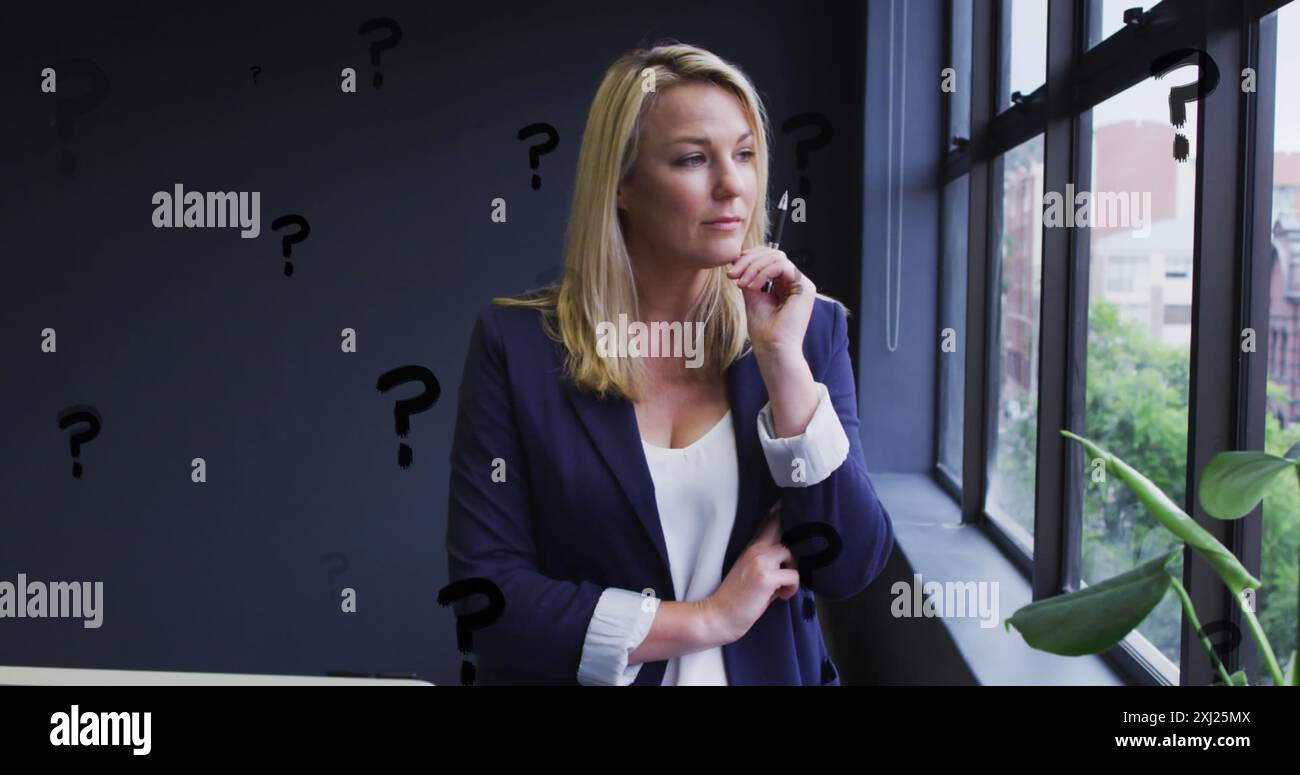 Image of question marks over caucasian businesswoman working at office ...