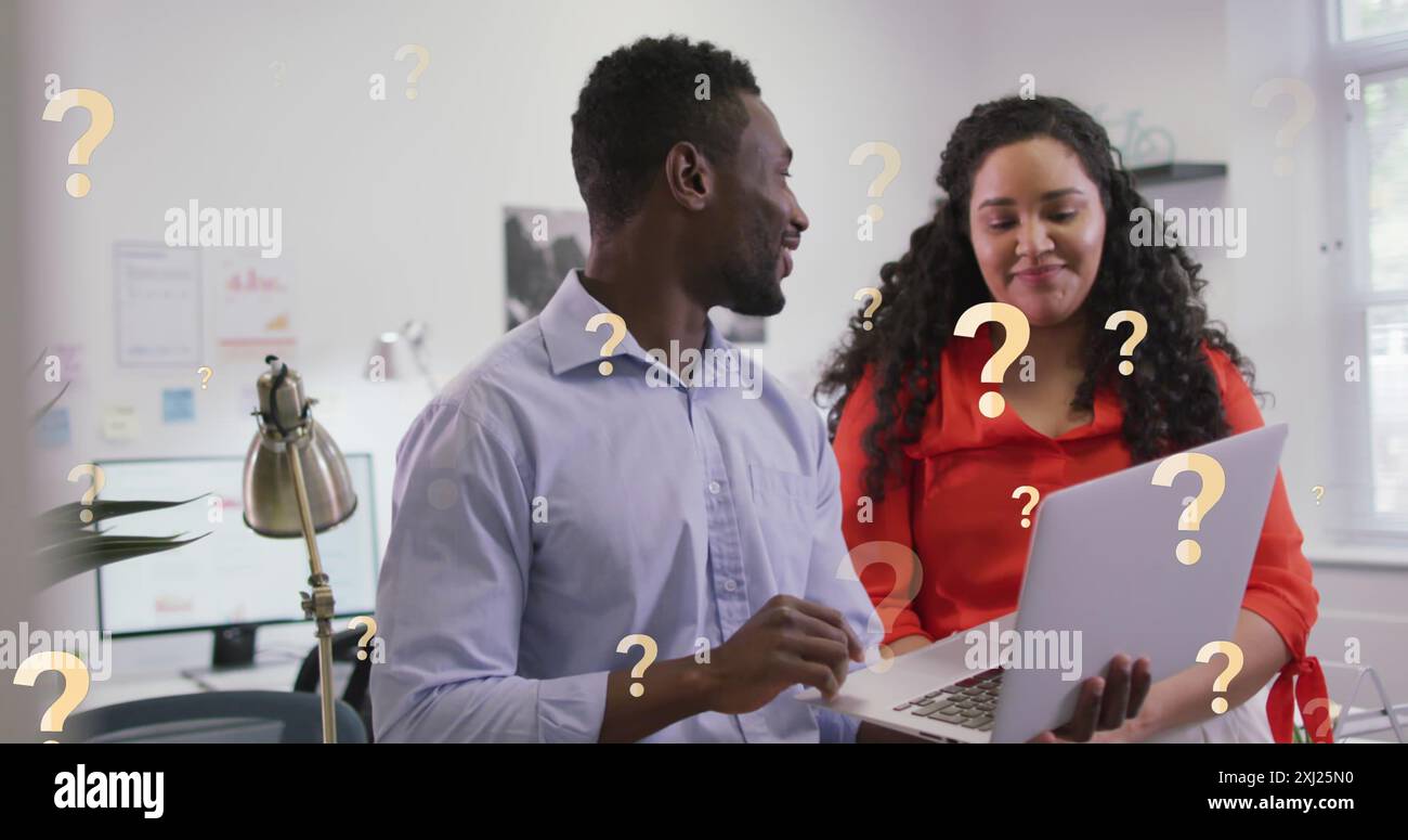 Image of question marks over diverse business people working at office ...