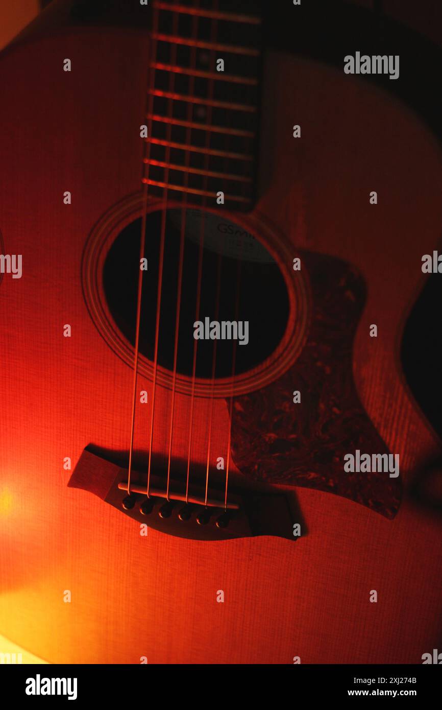 An evocative image of a steel-stringed guitar top, captured in warm ...