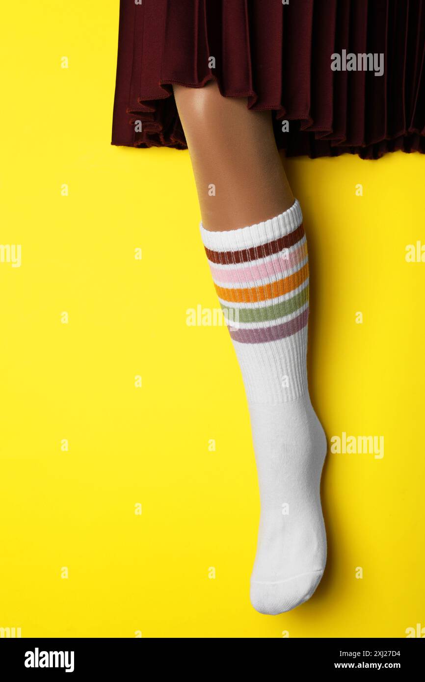 Woman wearing color sock on yellow background, closeup Stock Photo - Alamy