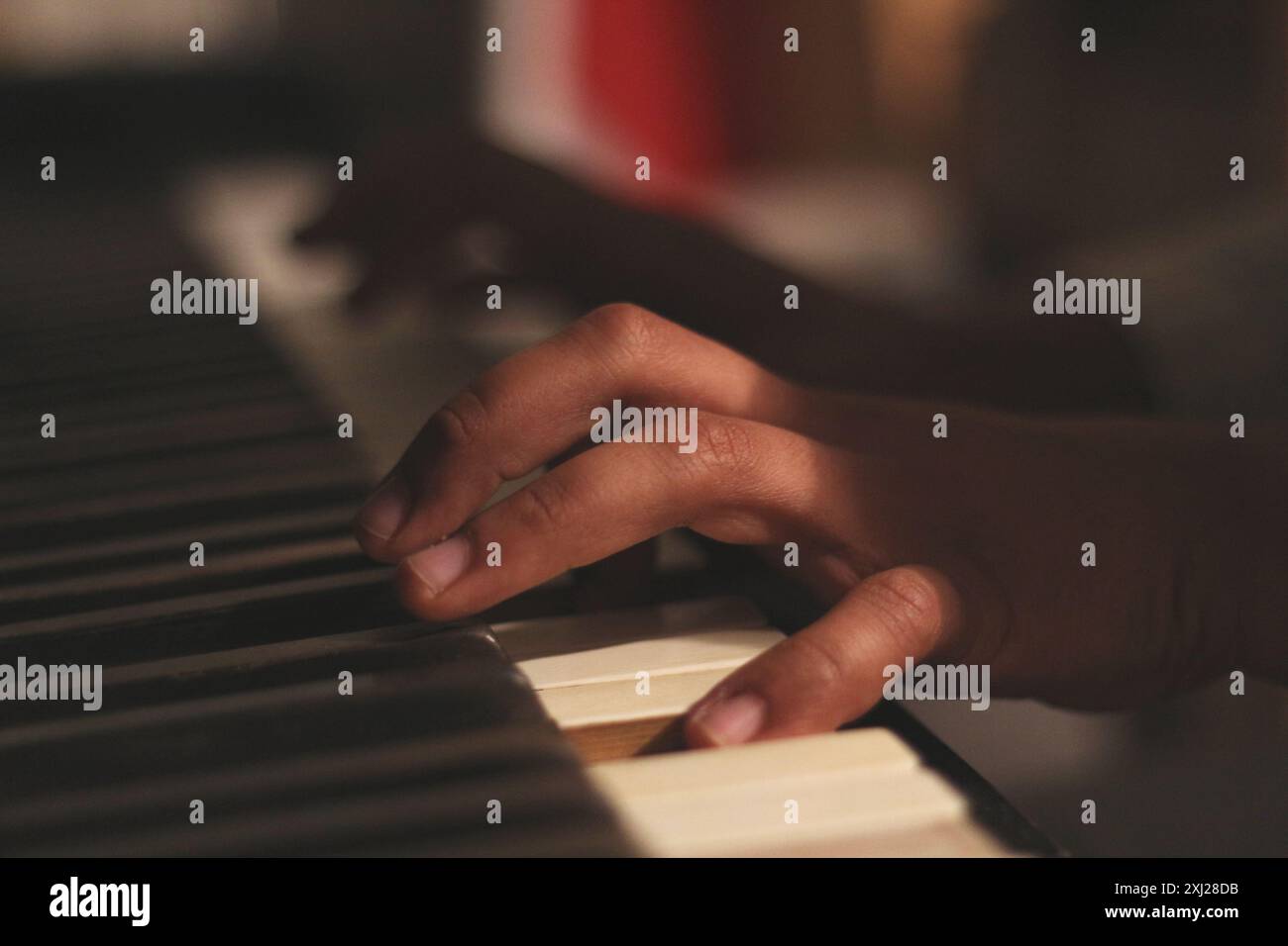 A captivating image of a black man's hands playing an old honky tonk ...