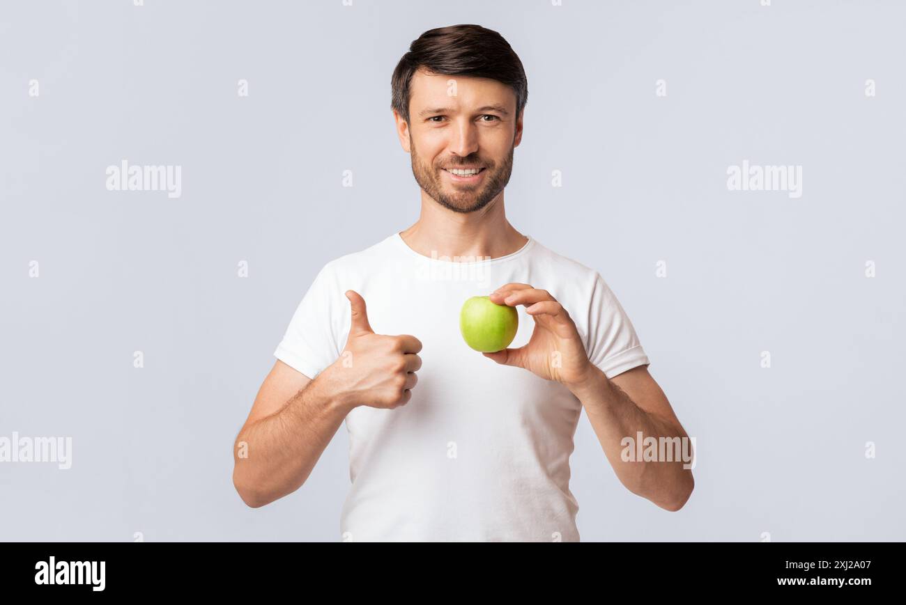 Smiling man giving apple hi-res stock photography and images - Alamy