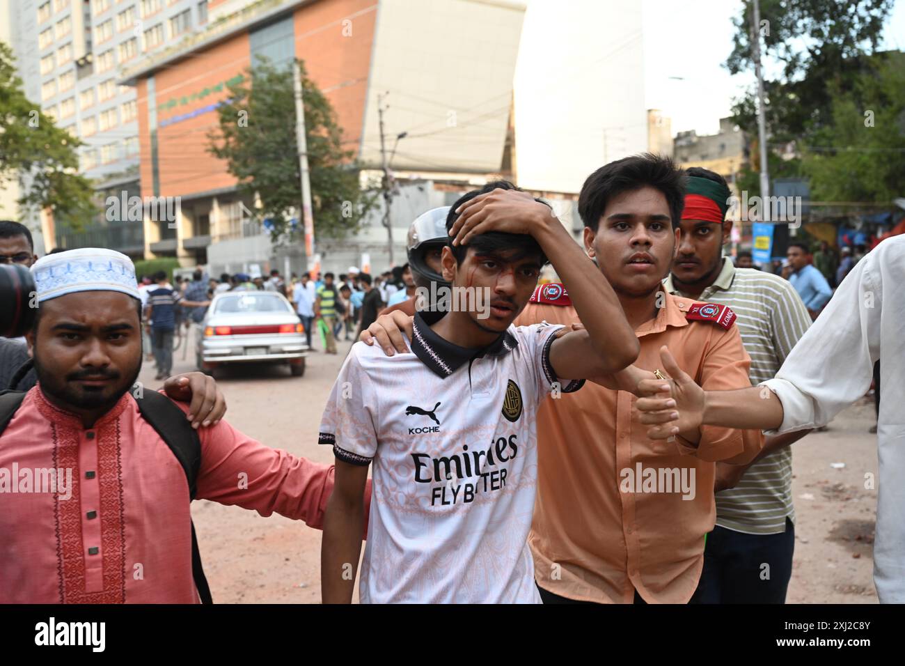An injured Anti-quota protesters seen and students backing the ruling ...