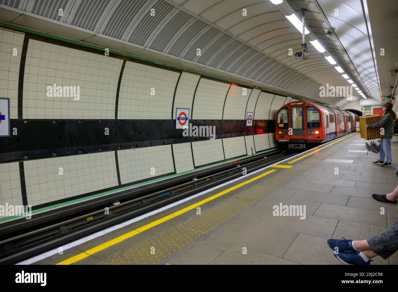 A tube train leaving/arriving at a platform at Wanstead Tube Station ...