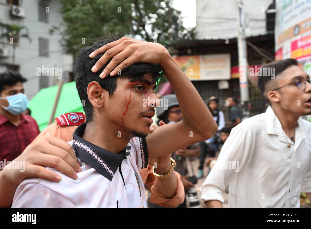 An injured Anti-quota protesters seen and students backing the ruling ...