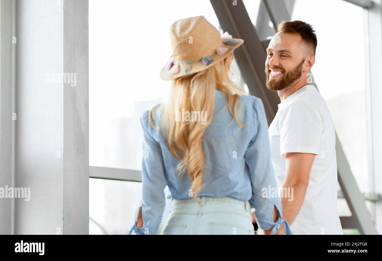 Loving couple waiting for flight near window of airport terminal Stock ...