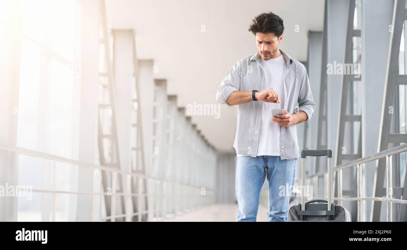 Worry Man Looking At Wristwatch In Airport, Late For His Flight Stock ...