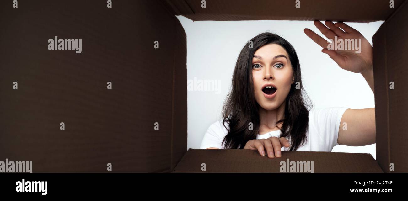 Woman Reacts With Surprise While Opening a Package Stock Photo - Alamy