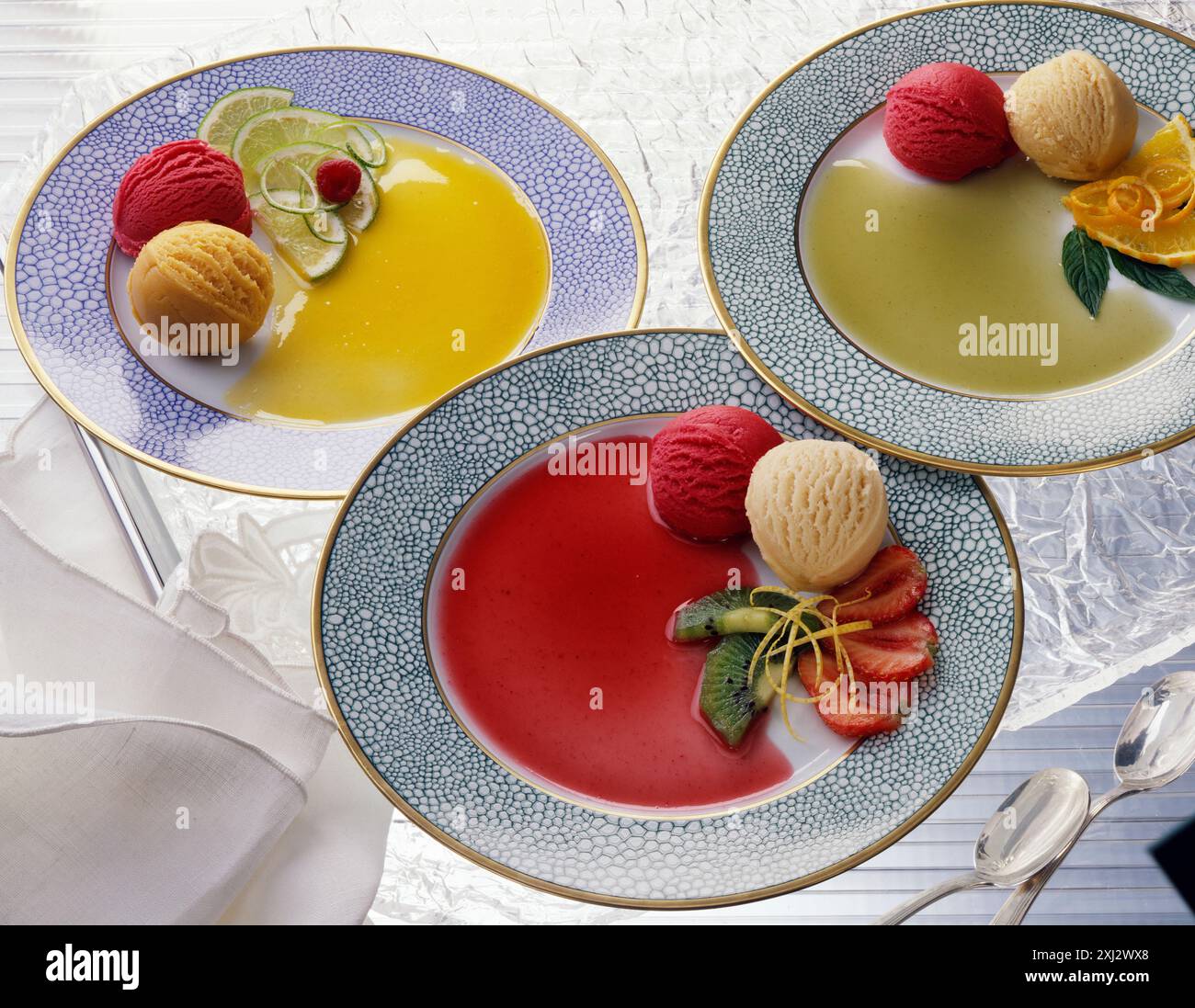 Three different coloured chilled fruit coulis with ice cream Stock ...