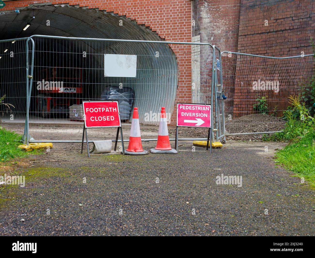 Footpath closed with pedestrian diversion signs and barriers at the ...