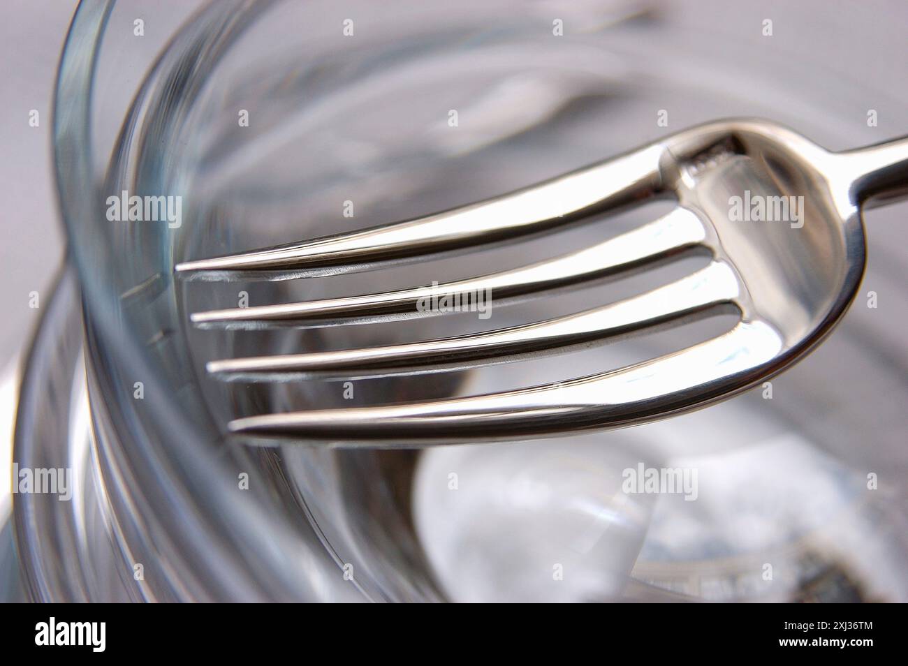 Fork and glass bowl Stock Photo - Alamy