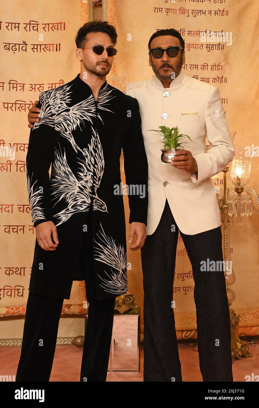 Bollywood actor Jackie Shroff (R) holds a potted plant as they pose for ...
