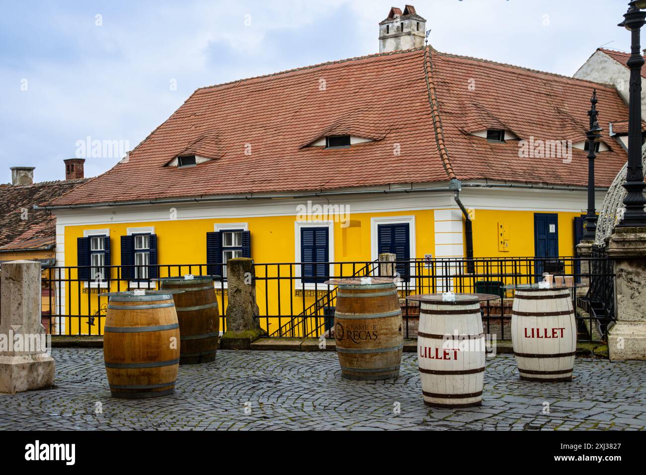 Traditional house in Sibiu with eye shaped attic windows. Barrels in ...