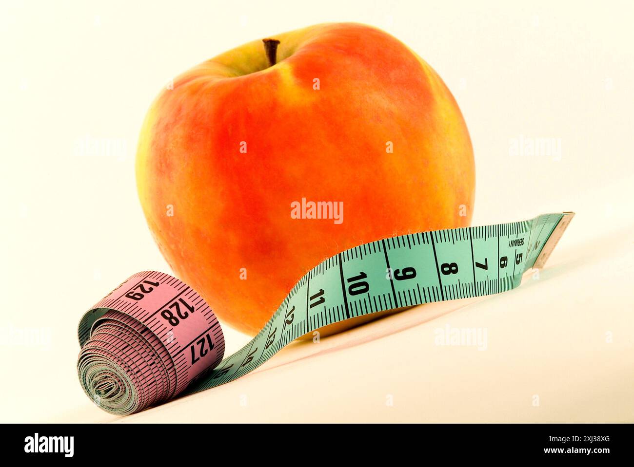 Apple and tape measure Stock Photo - Alamy