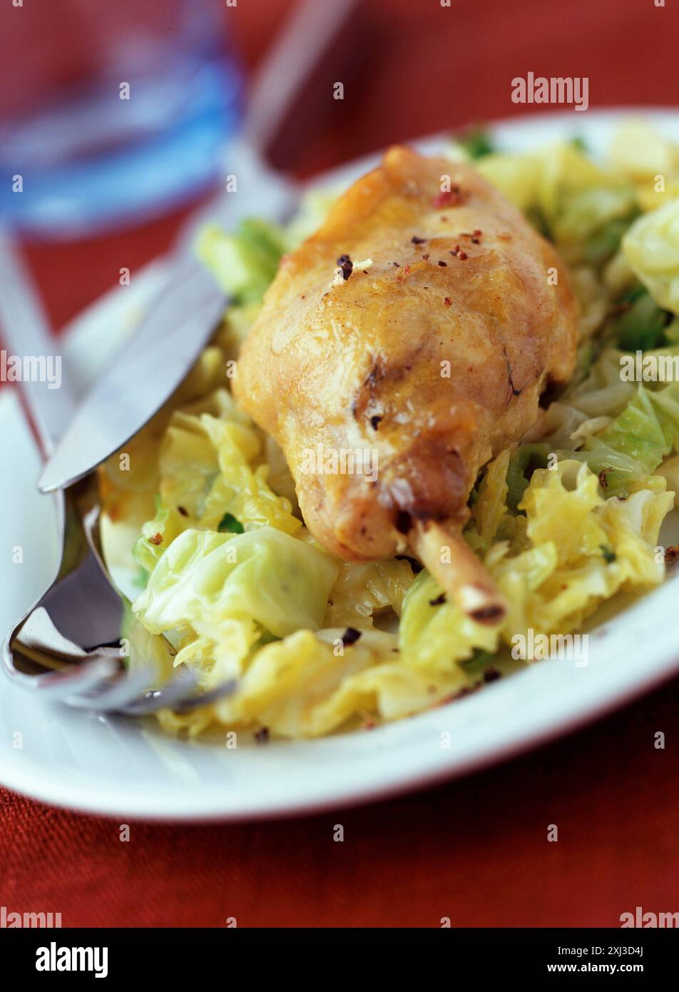 Rabbit leg with braised cabbage Stock Photo - Alamy