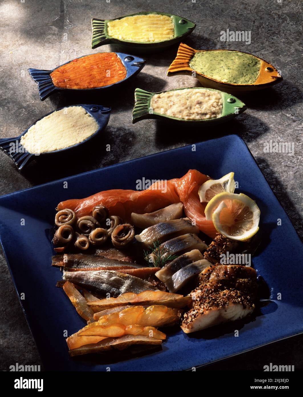 Smoked fish and different flavored butters Stock Photo - Alamy