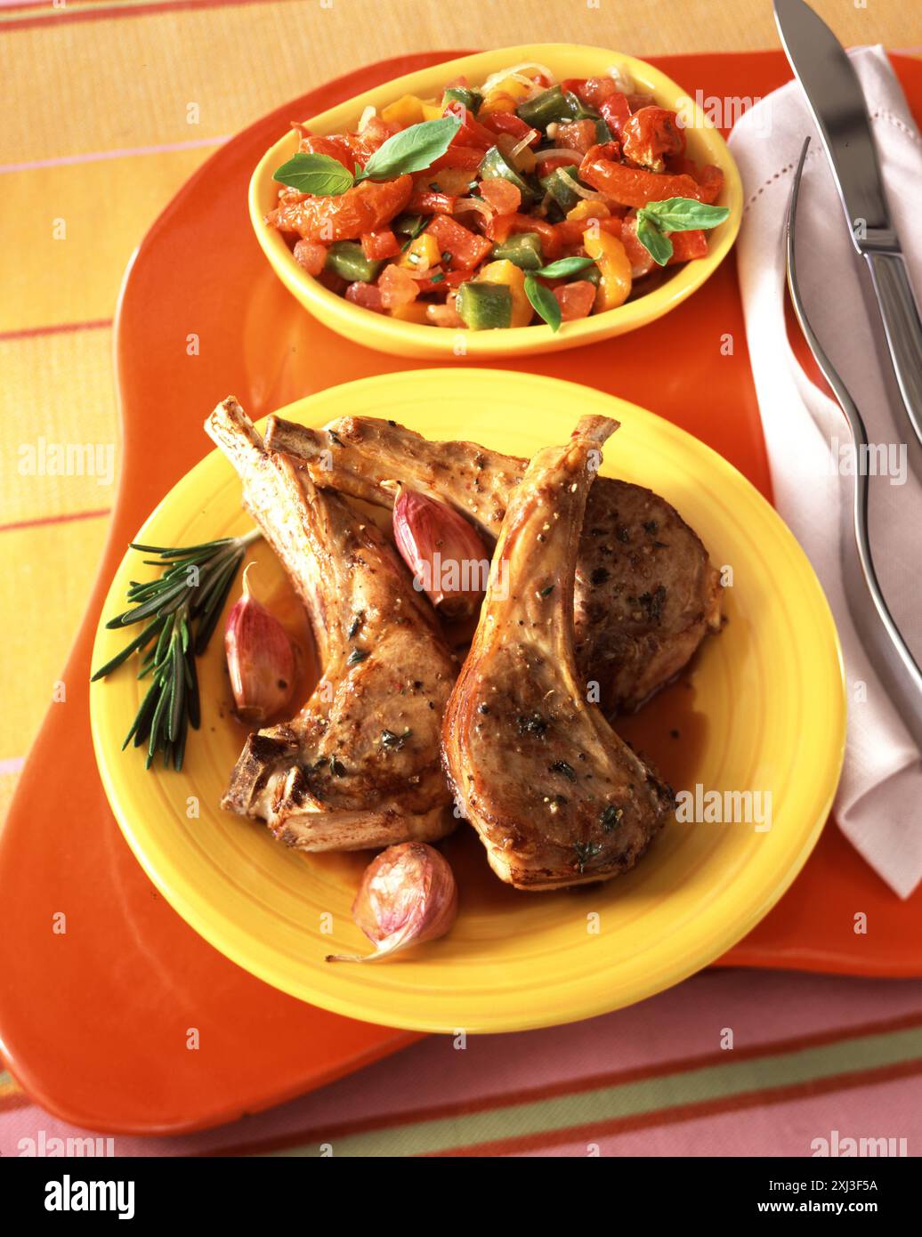 Lamb chops with thyme, and three colored stewed peppers Stock Photo - Alamy