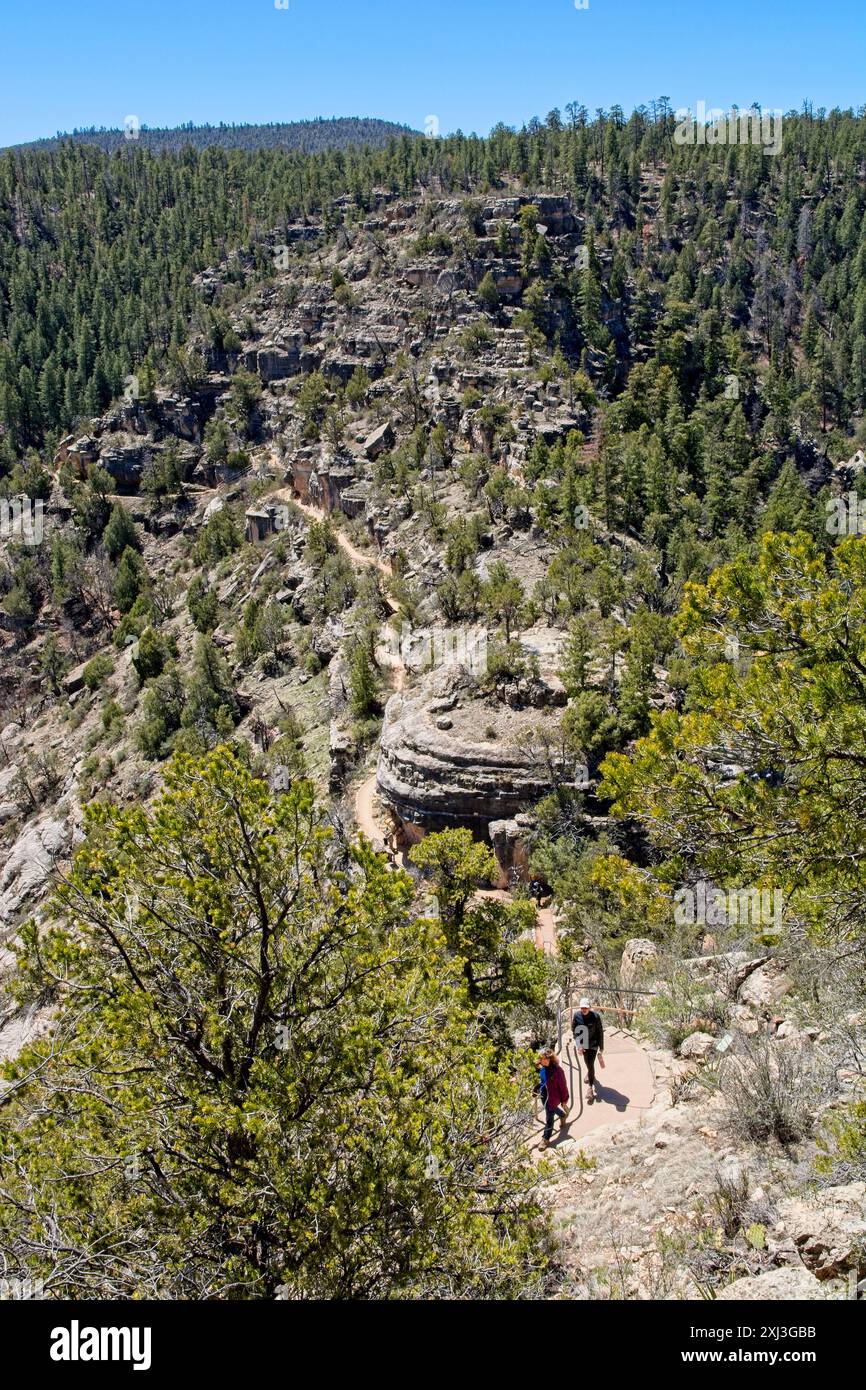 Visitors Hiking Up From Cliff Dwellings Along Island Trail At Walnut