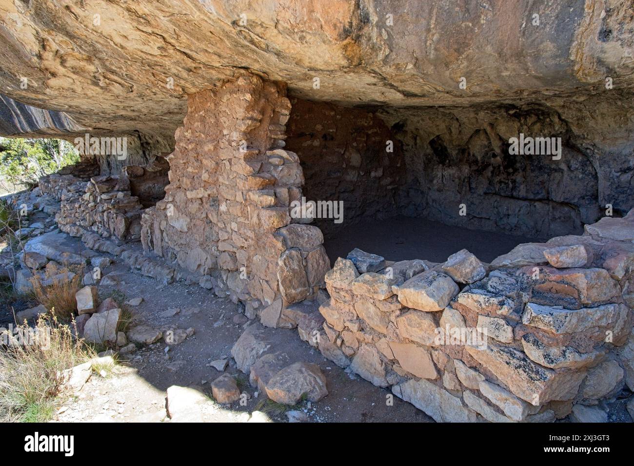 Ruins Of Masonry Cliff Dwellings Under Limestone Ledge In Walnut Canyon
