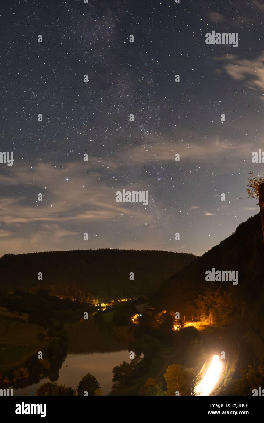 A stunning night sky with the milky way over a serene landscape with a ...