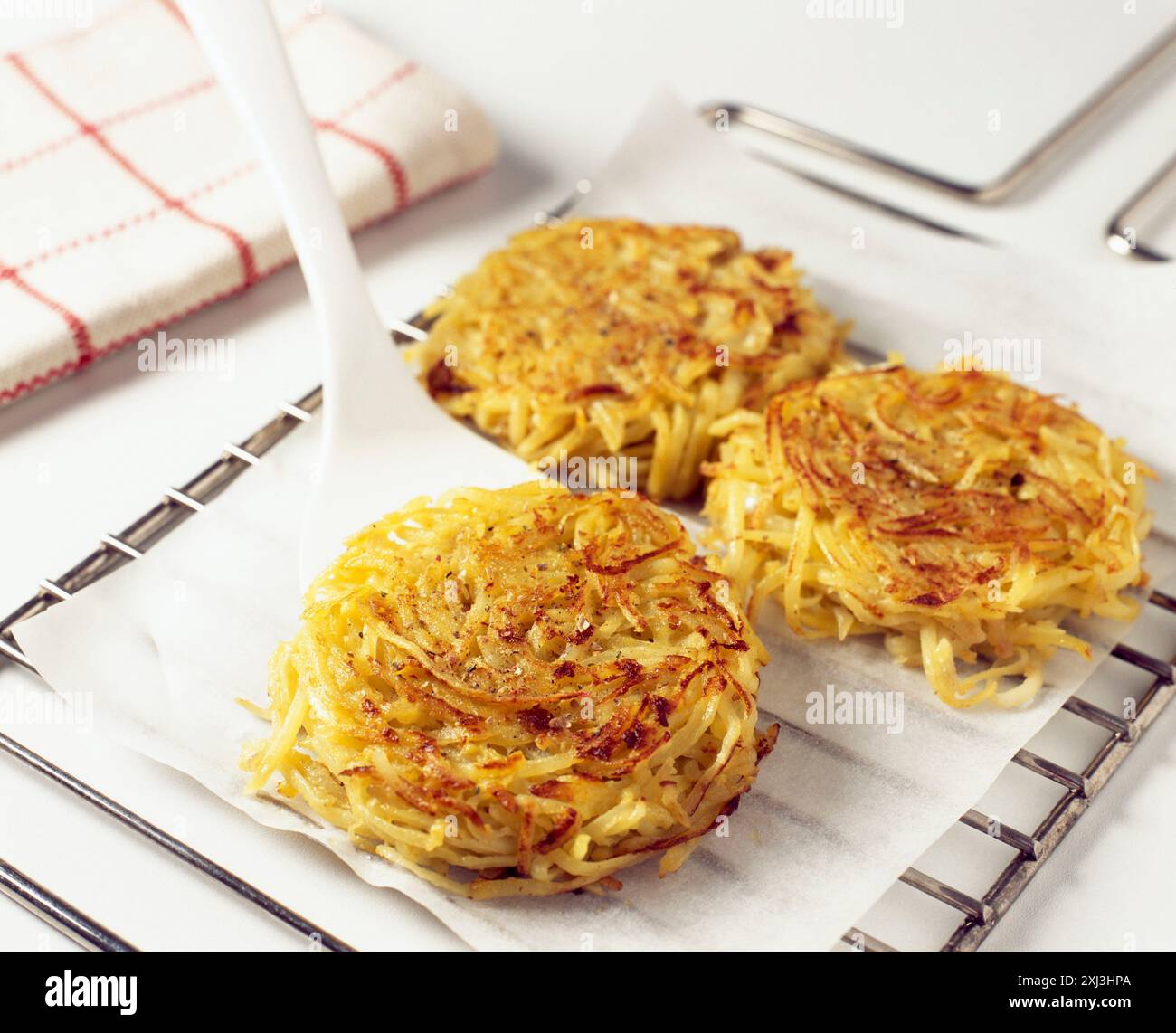 Draining the potato galettes Stock Photo - Alamy