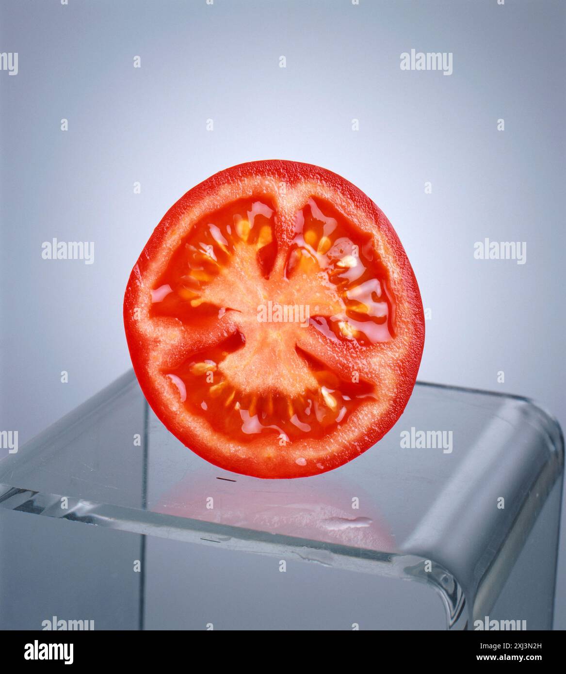 Tomato cut in half Stock Photo - Alamy