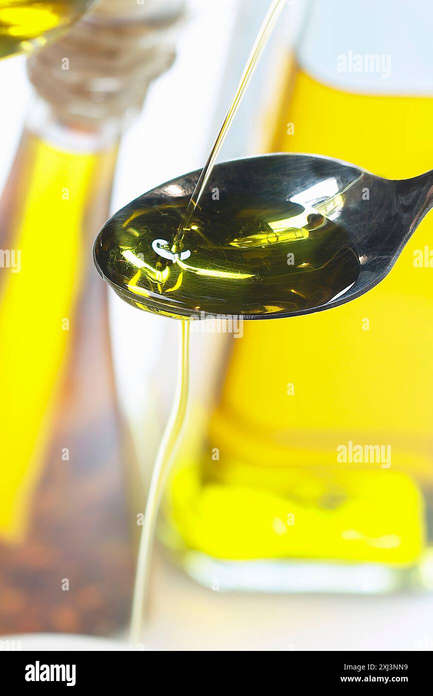 spoon of olive oil Stock Photo - Alamy