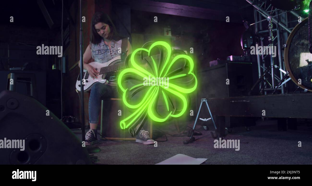 Image of st patrick's day green shamrock neon over woman playing guitar ...