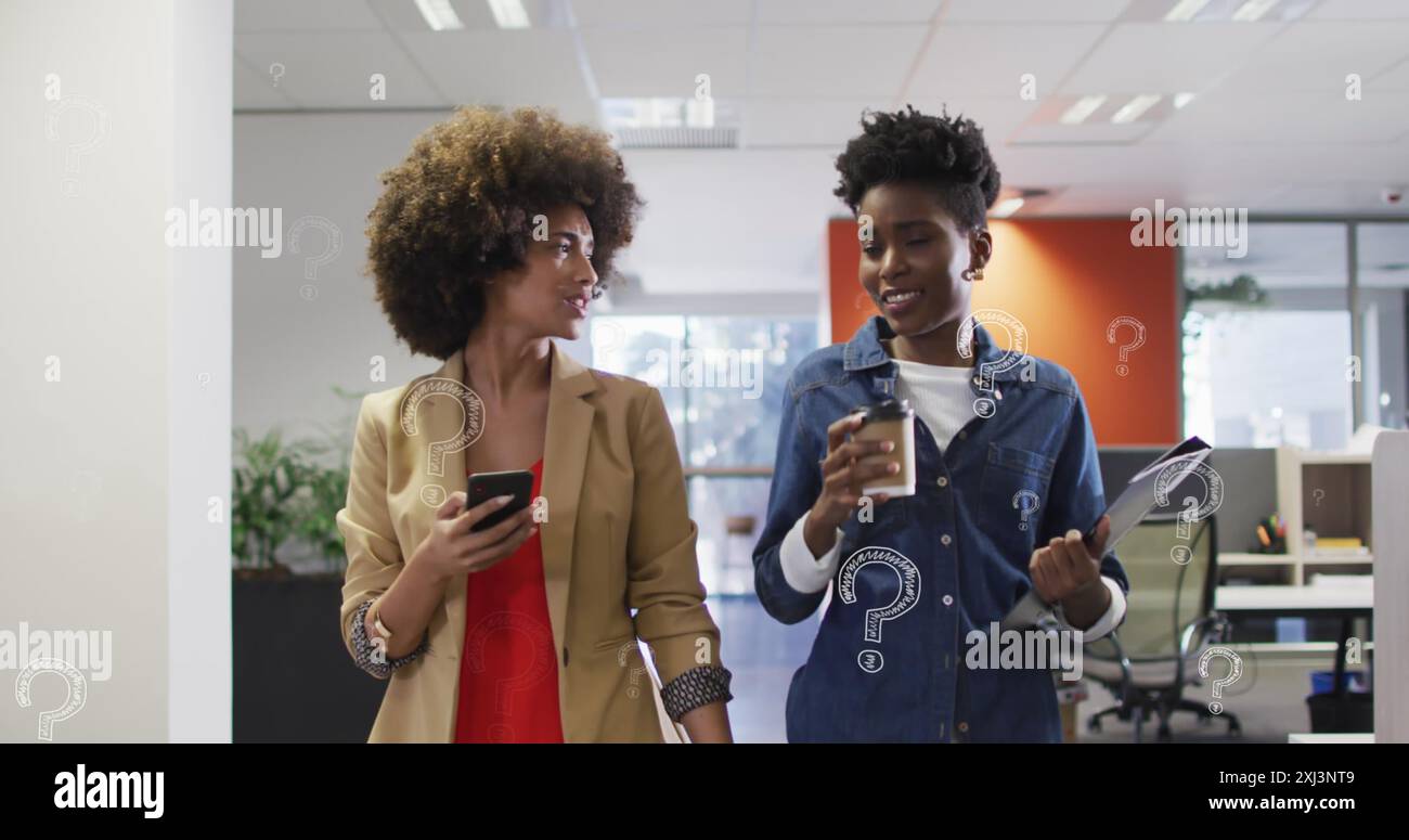 Image of question marks over diverse business people working at office ...